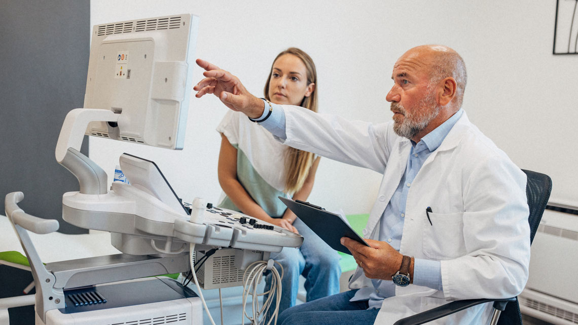 a medical researcher discusses imaging with a trial participant