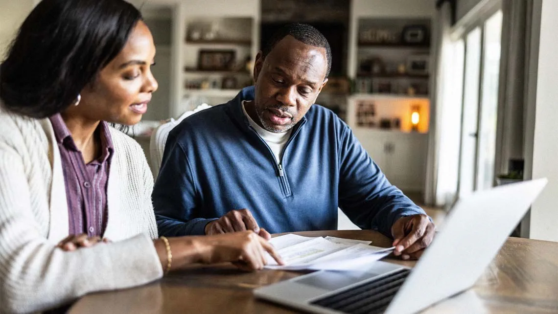a couple discusses health matters at the kitchen table together with a ...